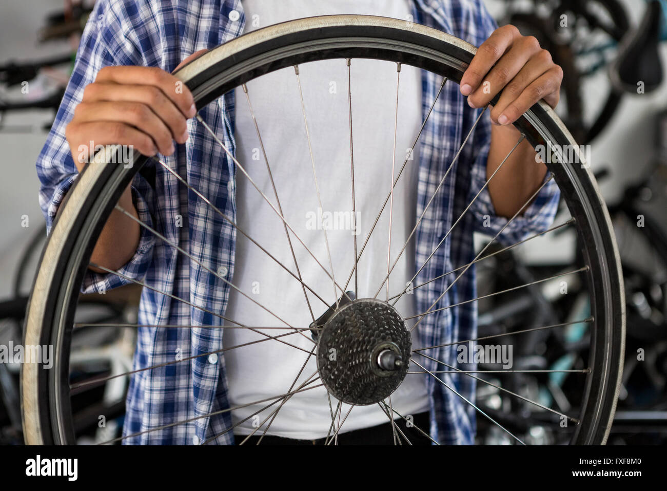 Worker repairing bicycles Stock Photo - Alamy
