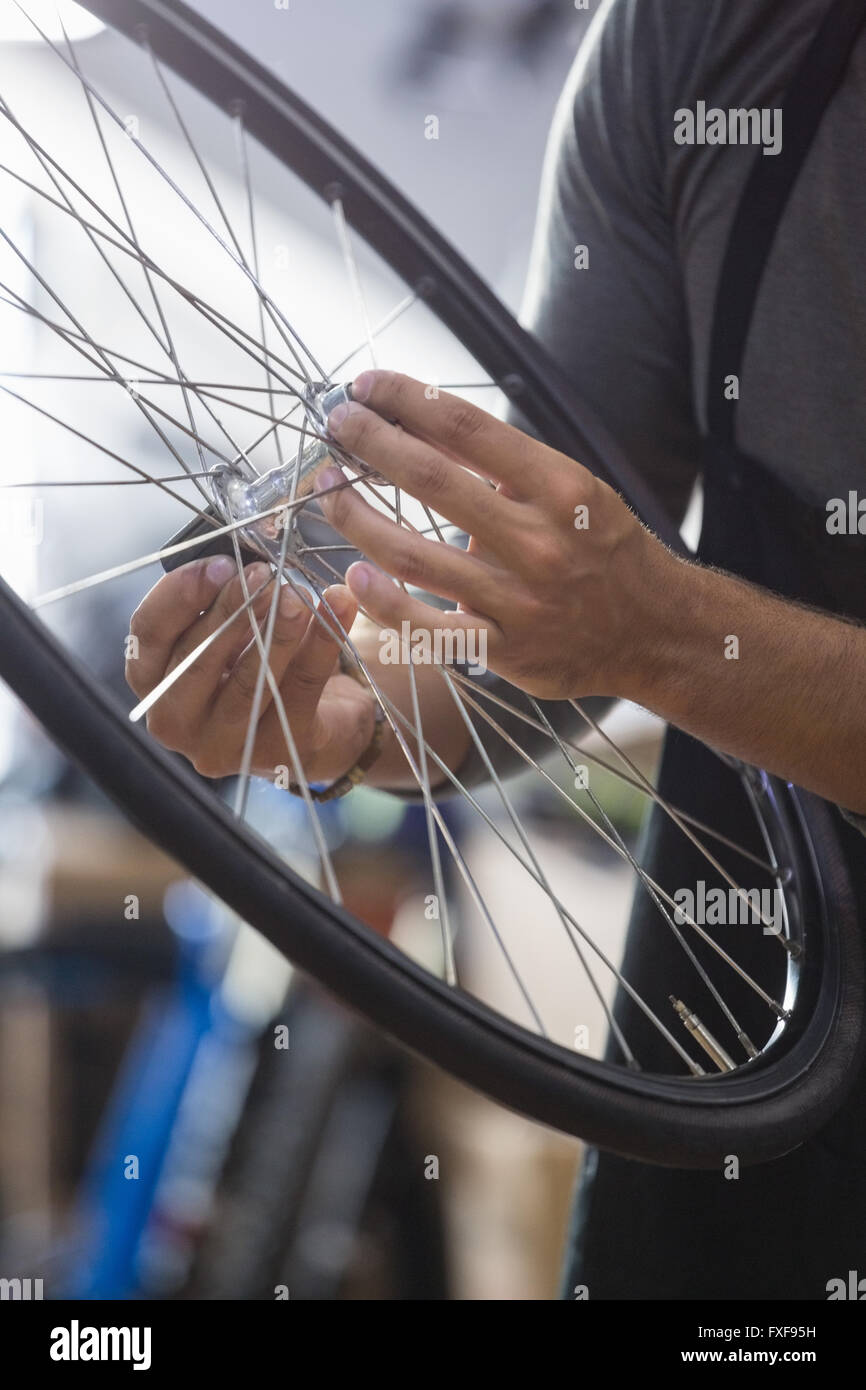 Worker repairing bicycles Stock Photo - Alamy