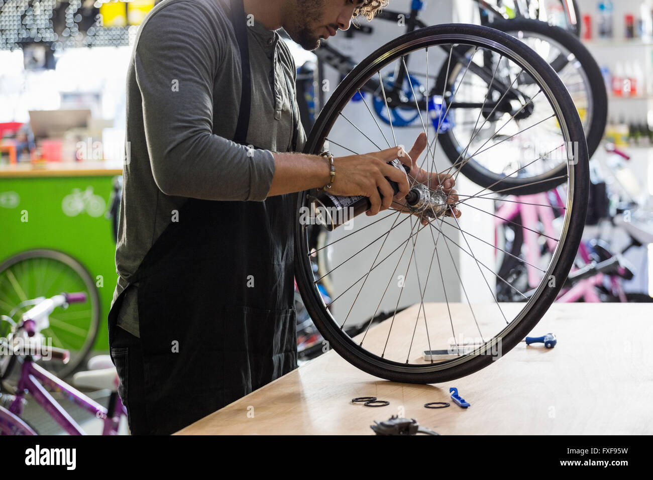 Worker repairing bicycles Stock Photo - Alamy