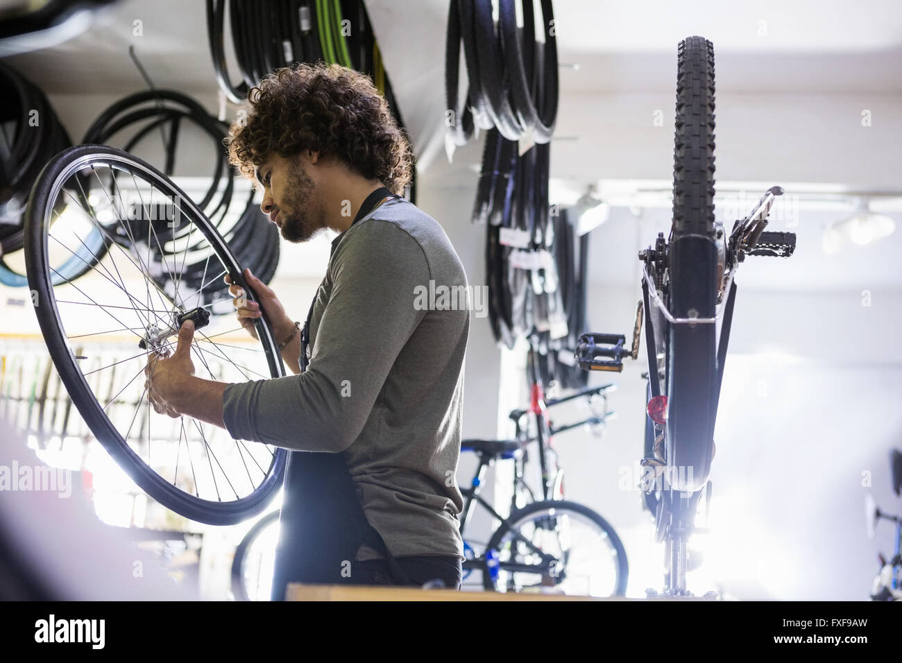 Worker repairing bicycles Stock Photo - Alamy