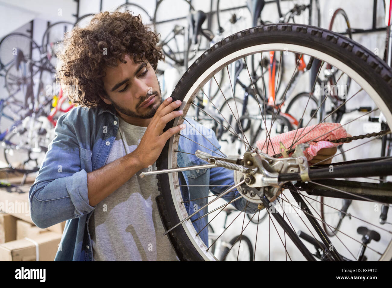 Worker repairing bicycles Stock Photo - Alamy