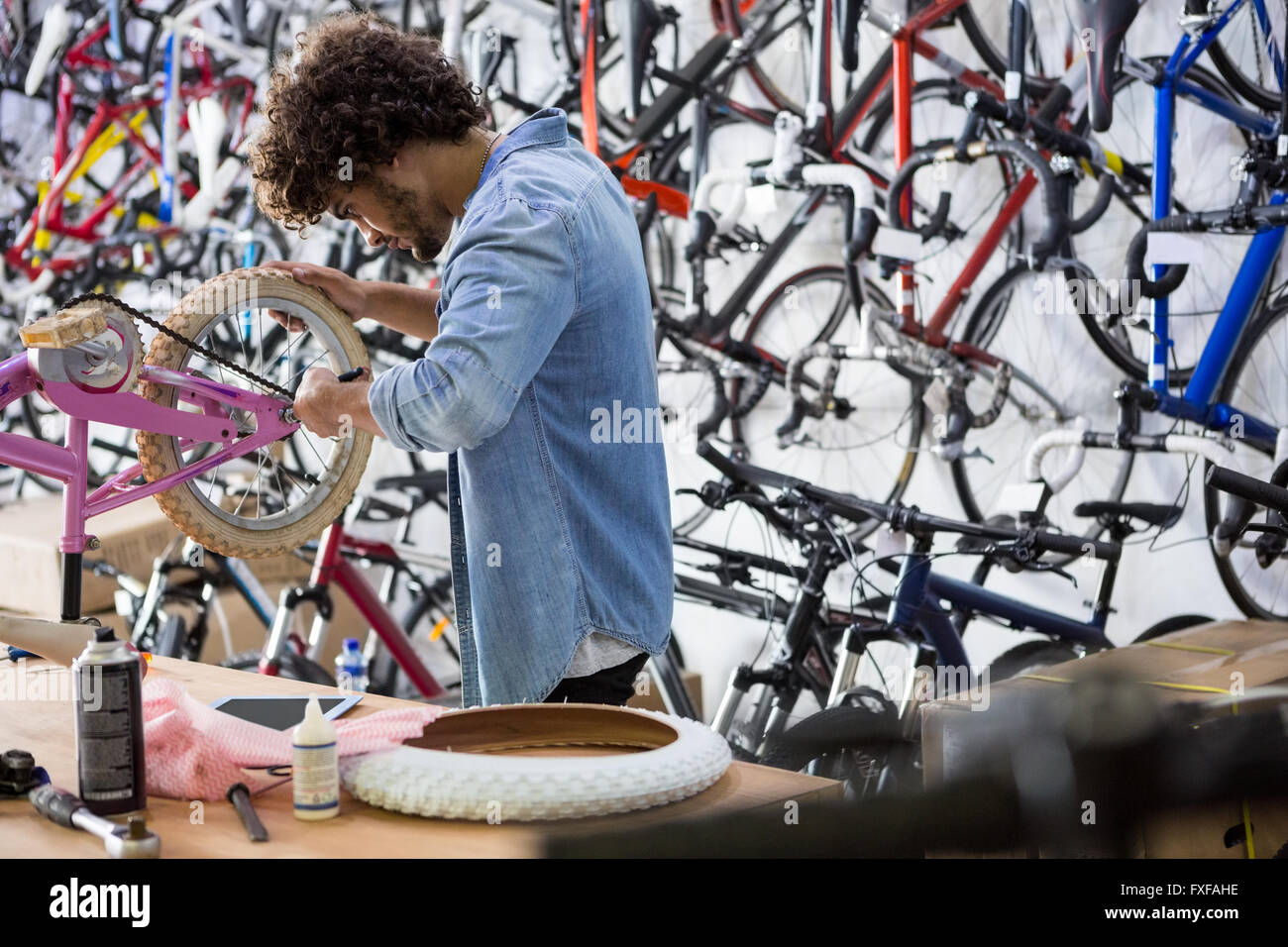 Worker repairing bicycles Stock Photo - Alamy