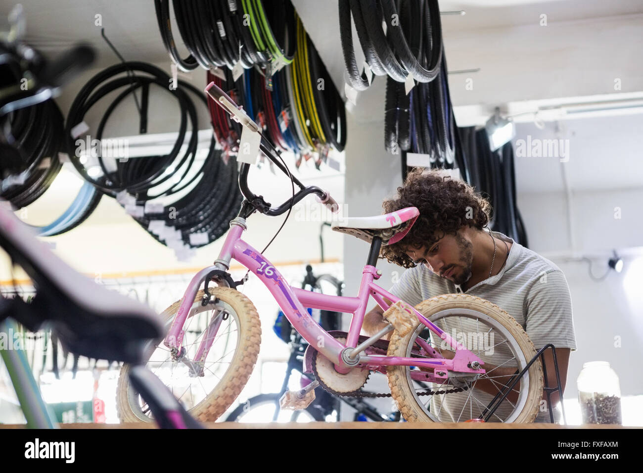 Worker repairing bicycles Stock Photo - Alamy