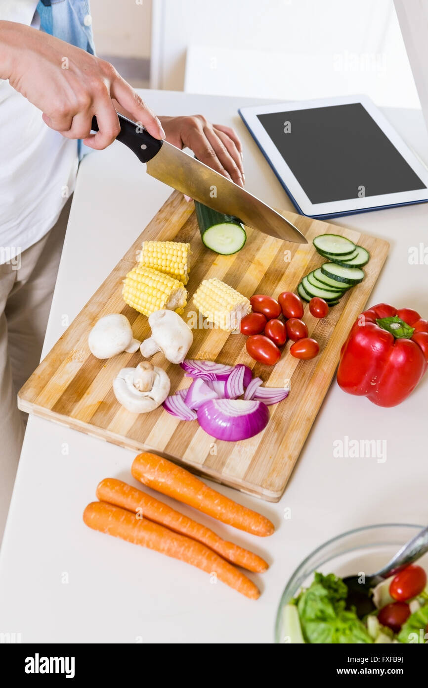 Mid-section of woman chopping vegetable in kitchen Stock Photo - Alamy