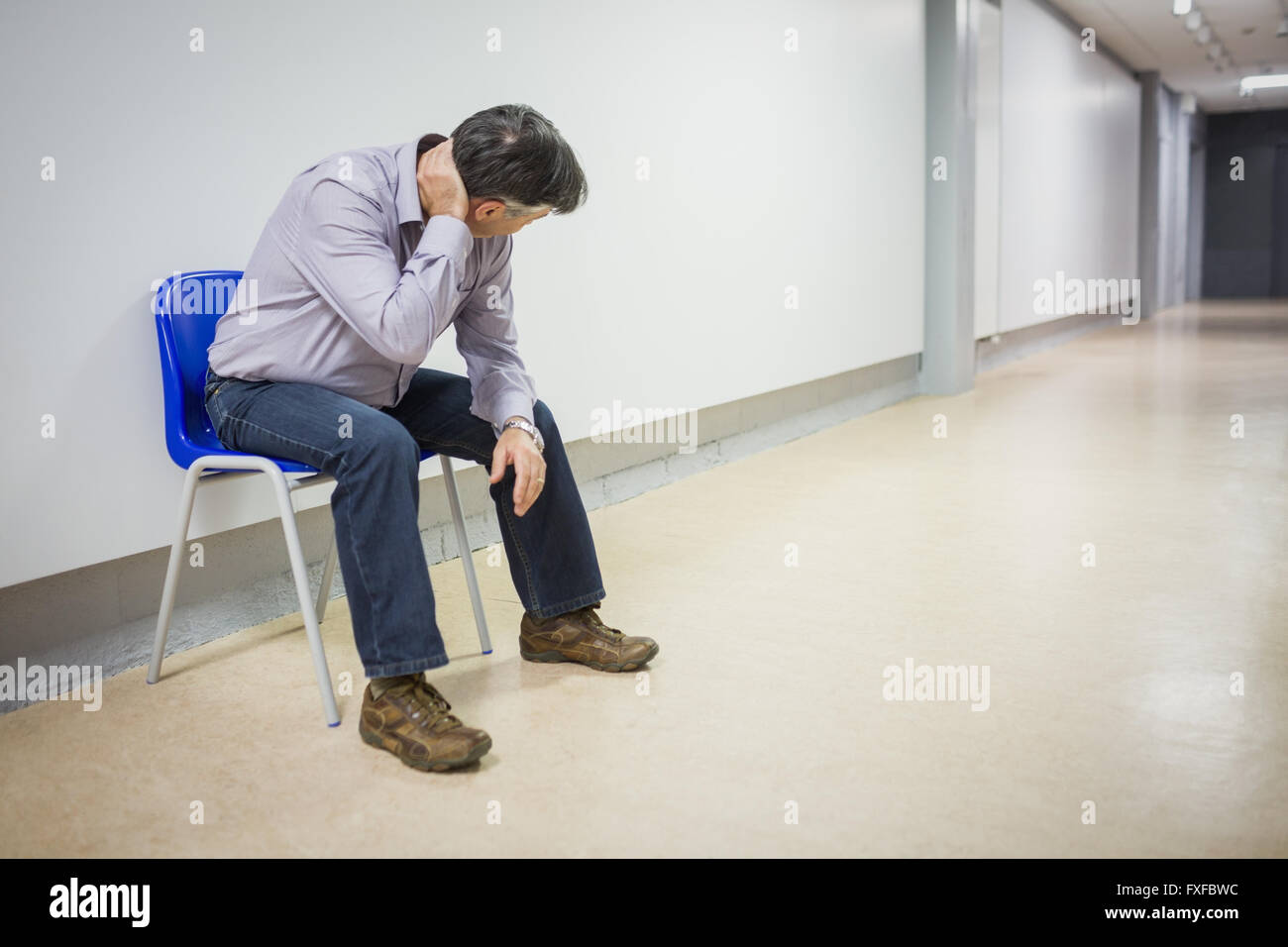 Professor sitting on chair Stock Photo - Alamy