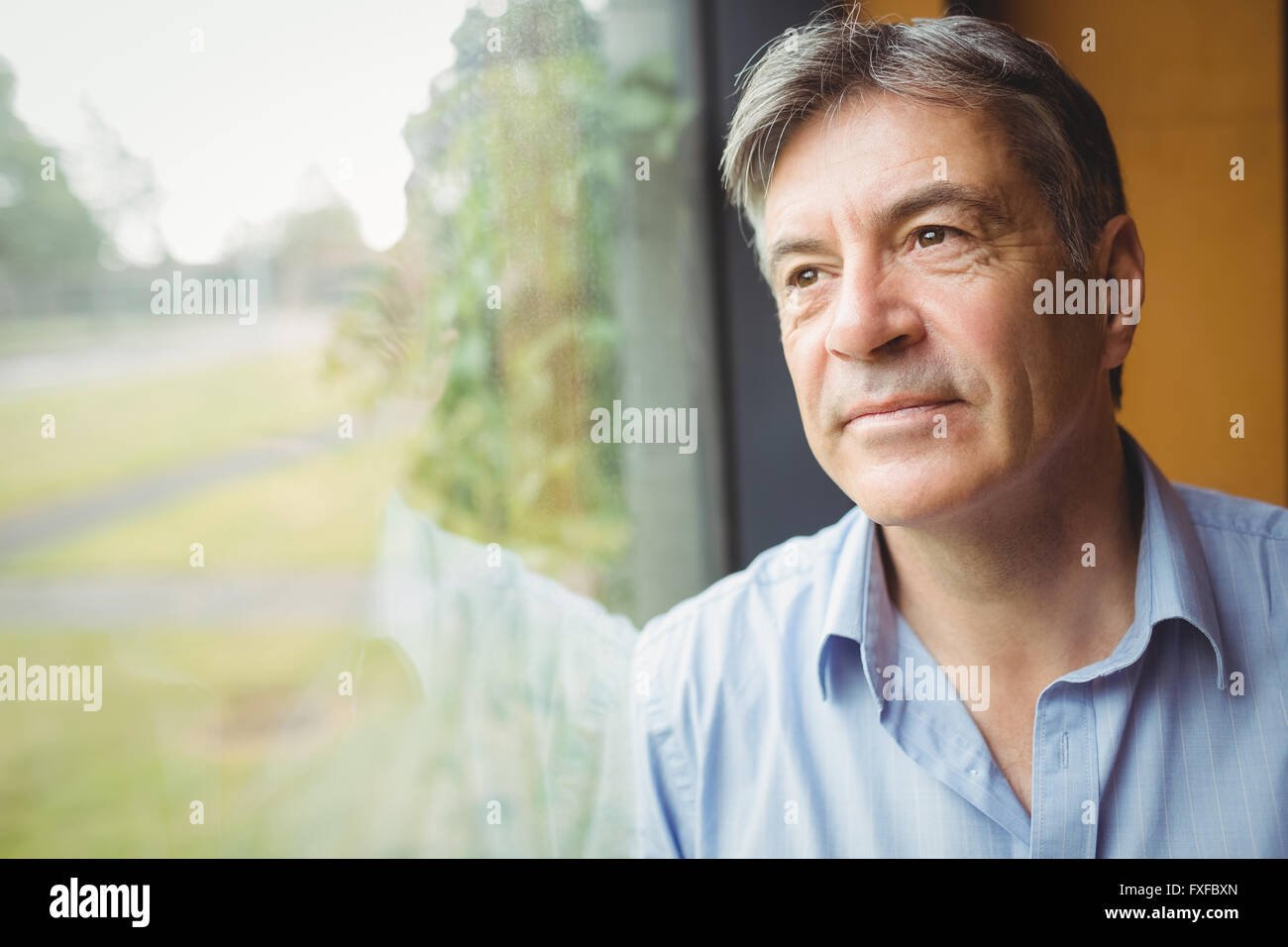 Man looking through the window hi-res stock photography and images - Alamy