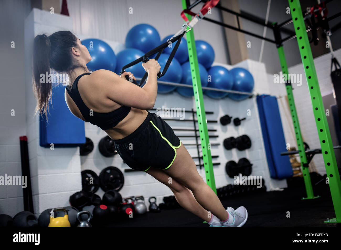 Woman doing suspension training with trx fitness straps Stock Photo - Alamy
