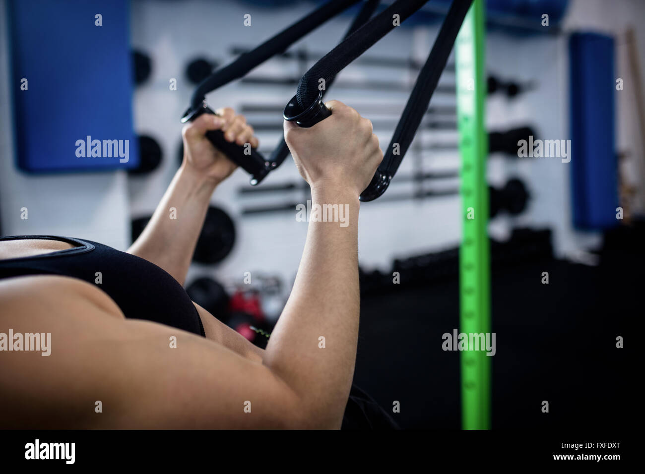 Woman doing suspension training with trx fitness straps Stock Photo - Alamy
