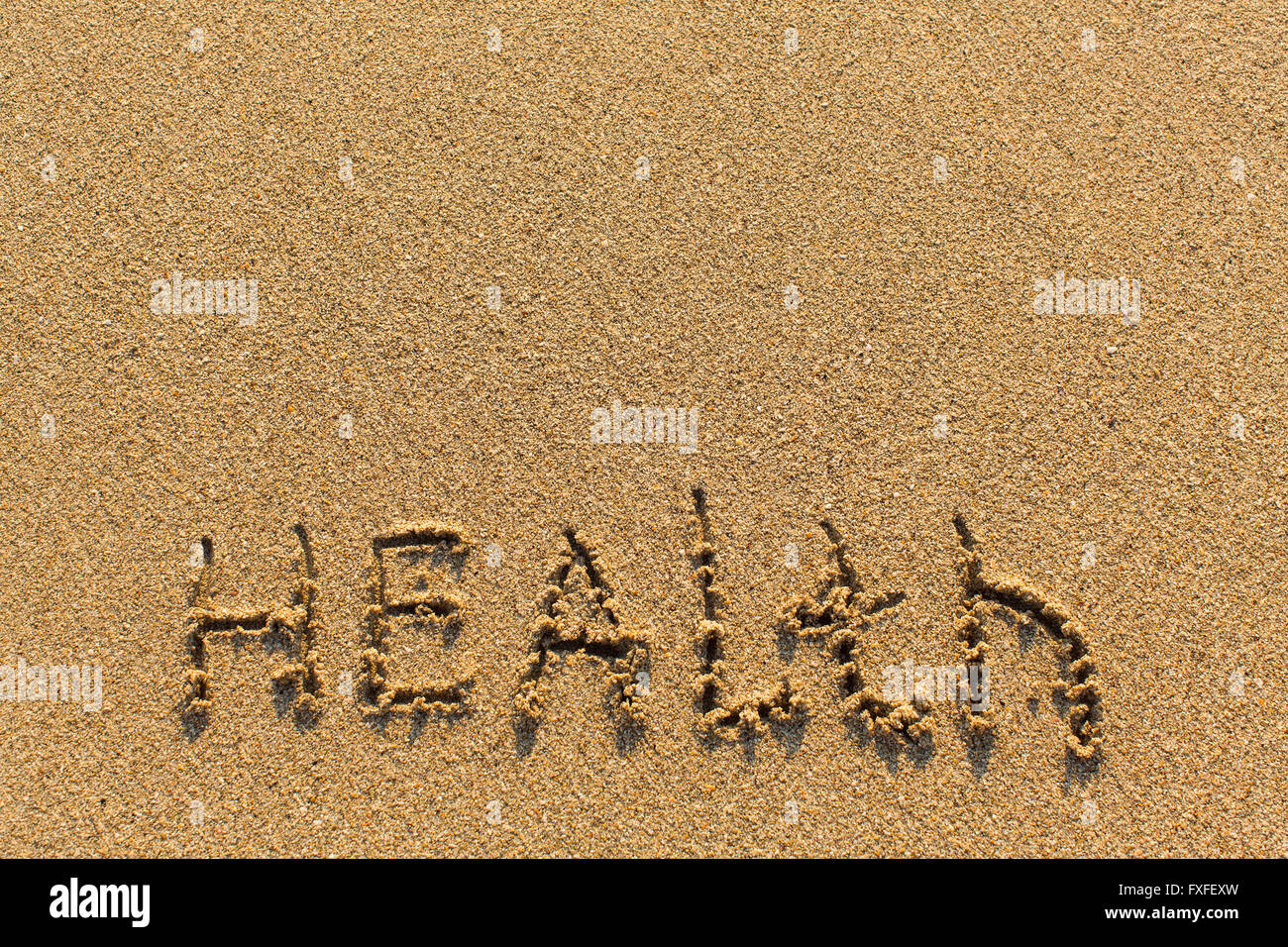 Health - drawn of the hand on the beach sand Stock Photo - Alamy