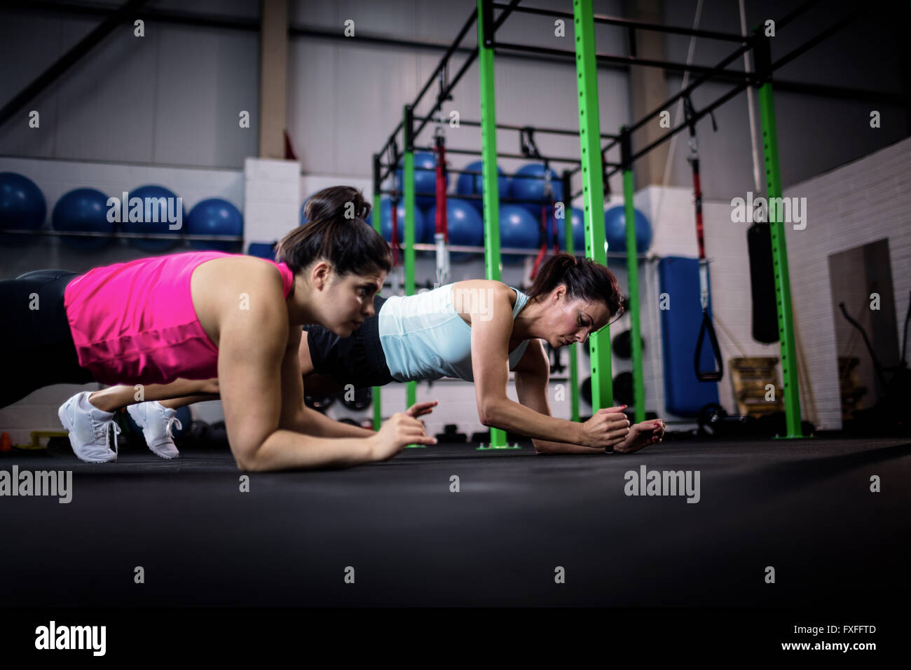 Women performing plank exercise at gym Stock Photo - Alamy