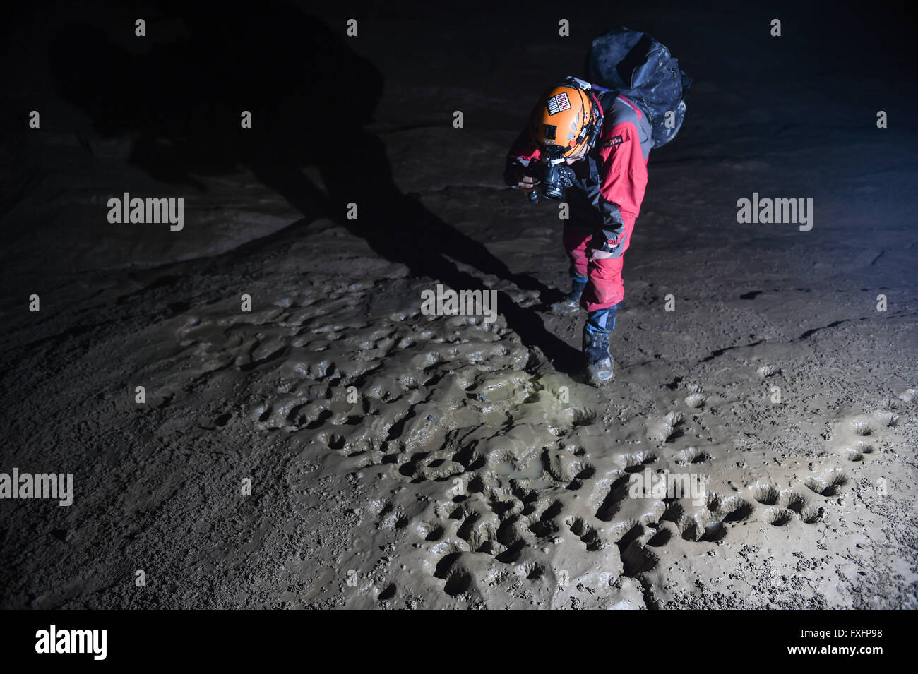 Ziyun, China. 15th April, 2016. An expedition member takes pictures ...