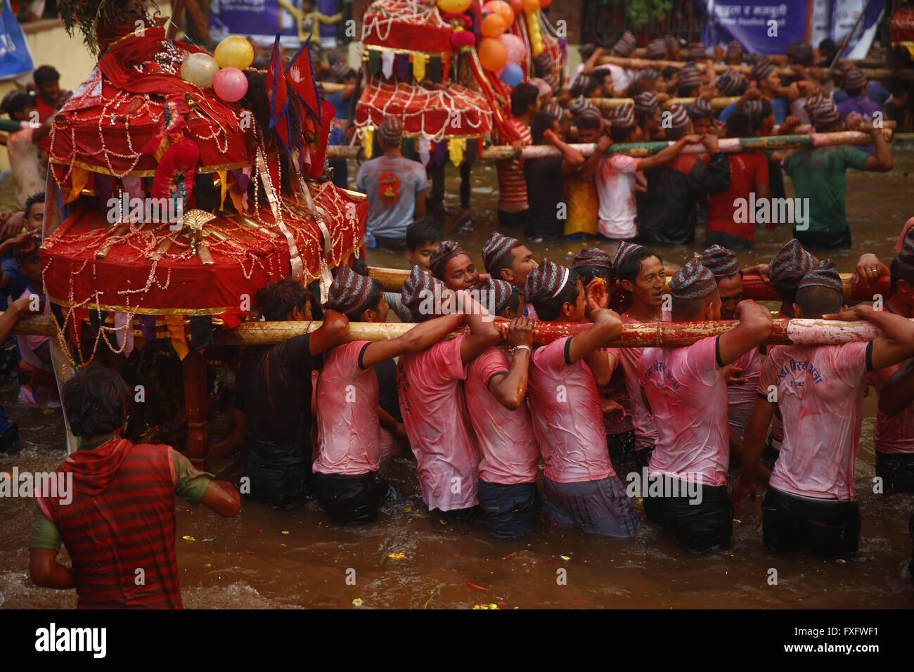 Kathmandu, Nepal. 15th Apr, 2016. Revellers carry chariots on their ...