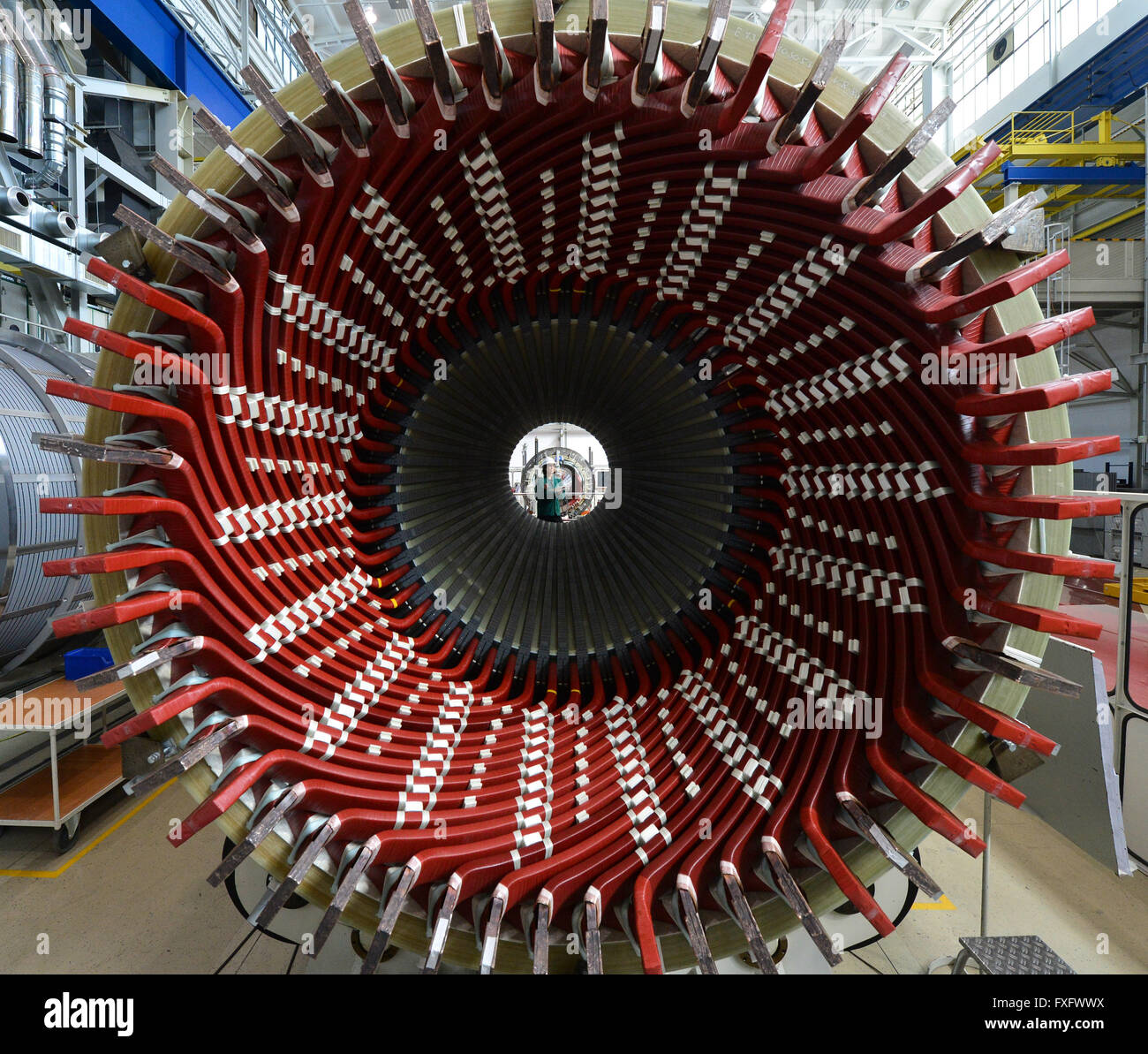Sandra Leissling, employee of Factory Services, looking at a generator ...