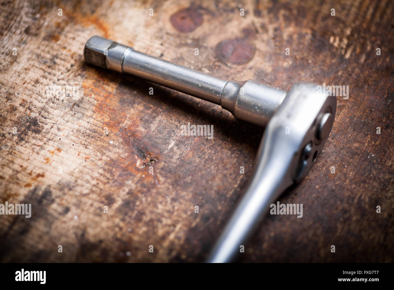 Color image of a socket spanner on a wooden plank Stock Photo - Alamy