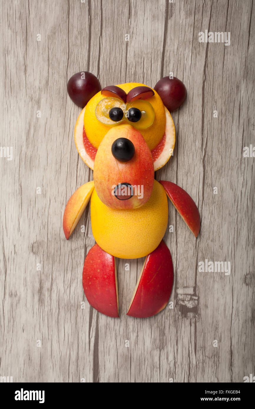 Amusing bear made of fruits on wooden background Stock Photo - Alamy