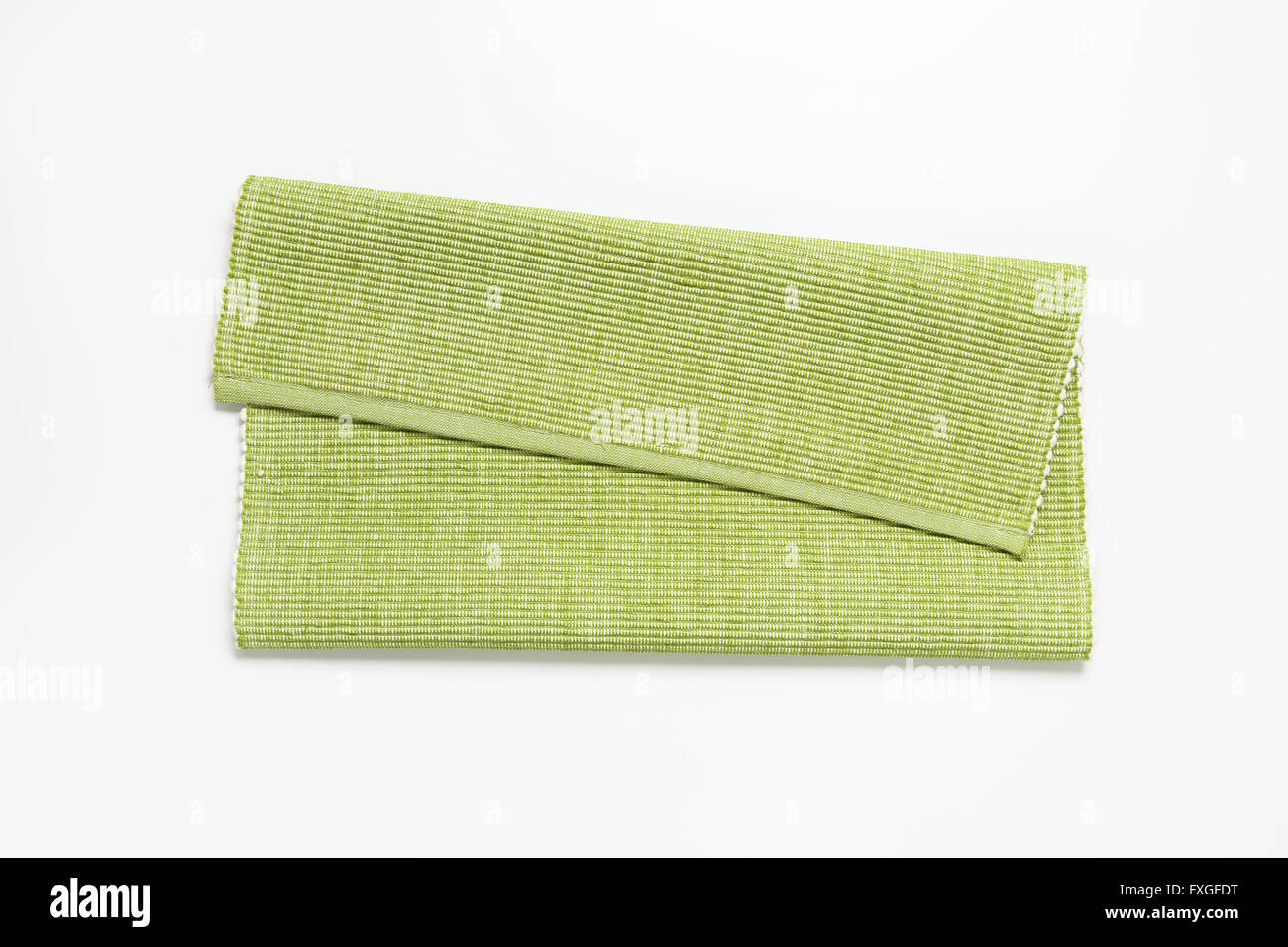 Folded light green place mat on white background Stock Photo - Alamy
