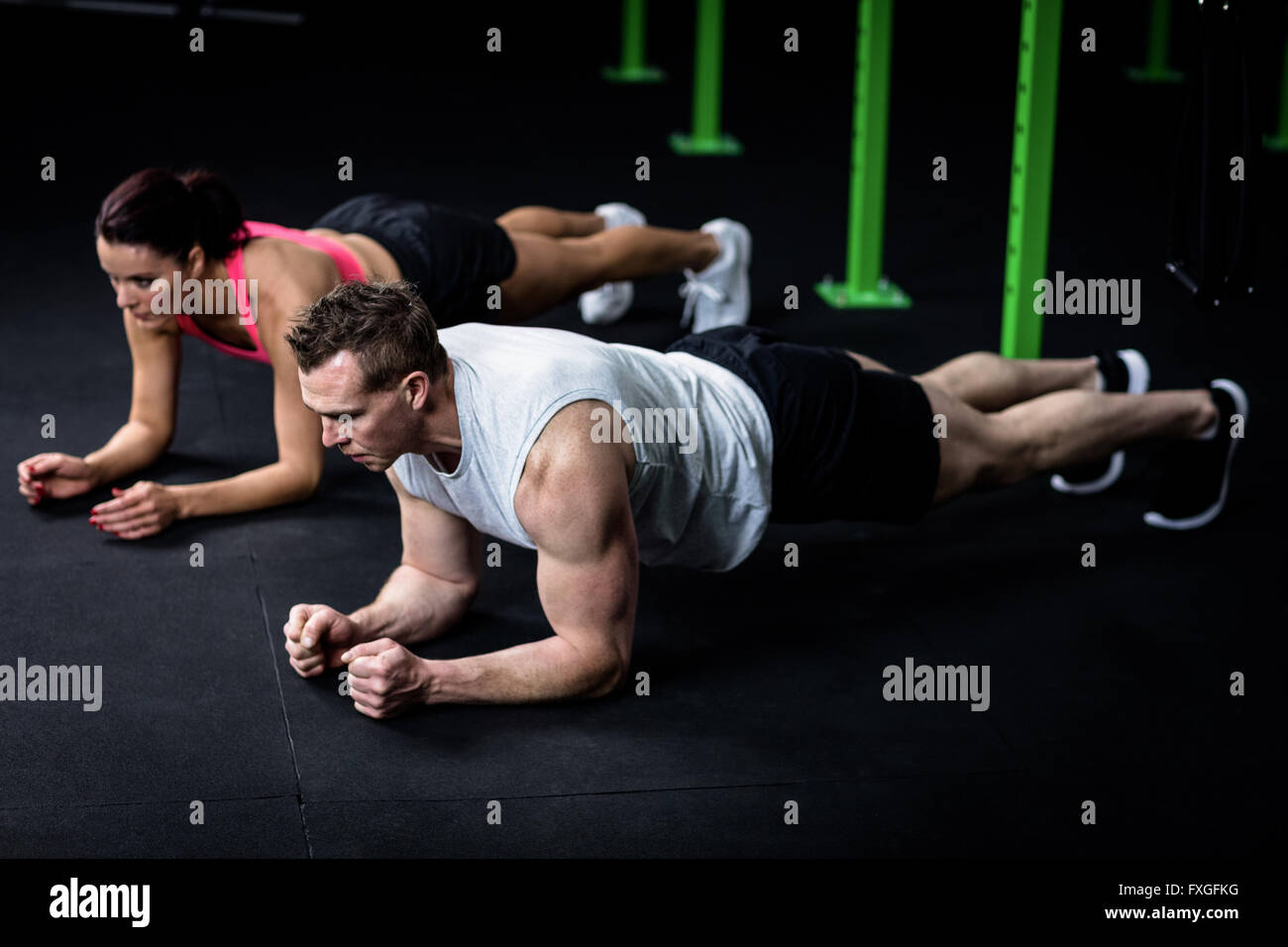 Man and a woman performing plank exercise Stock Photo - Alamy