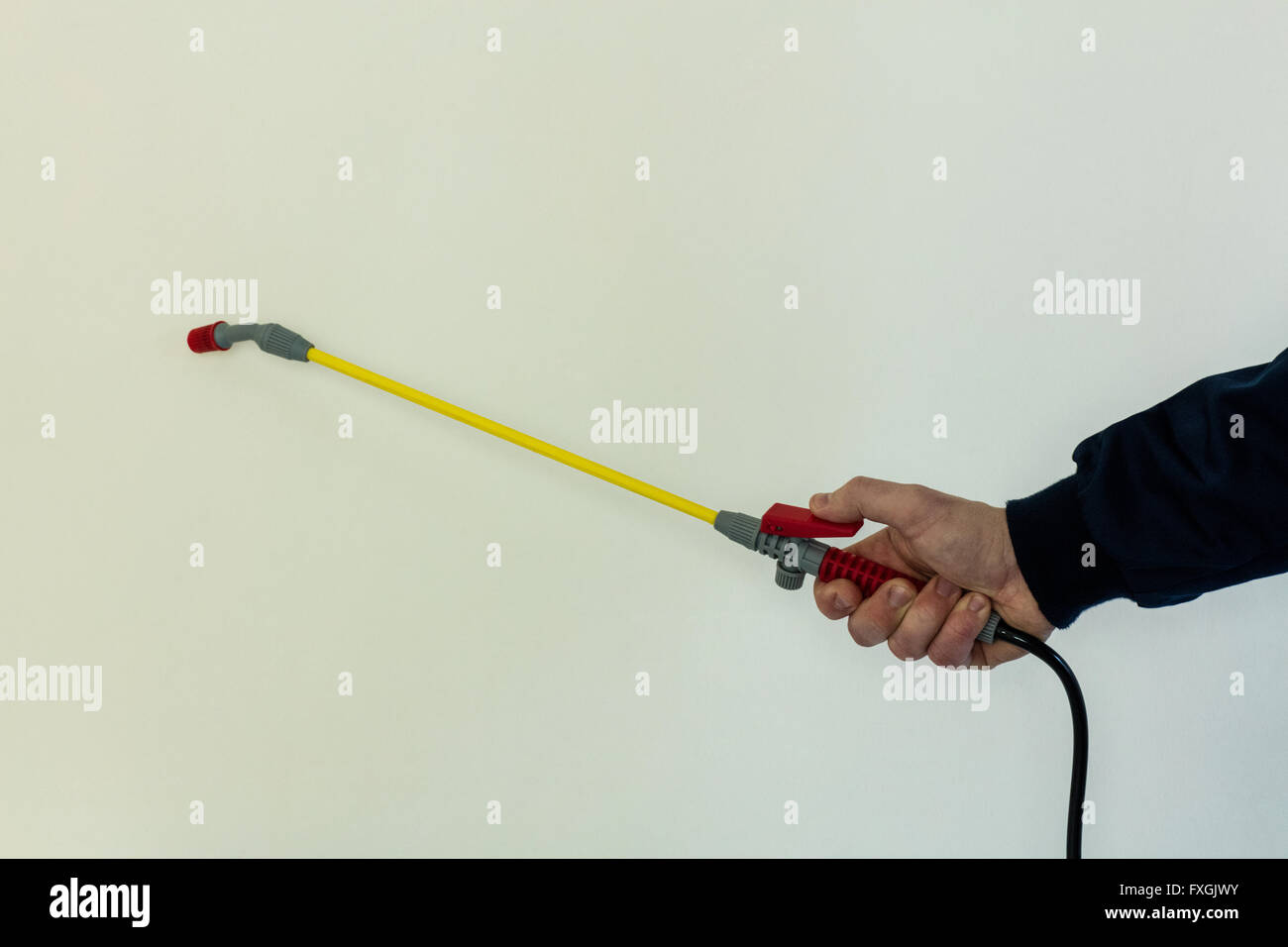 Mans hand spraying pesticide Stock Photo - Alamy