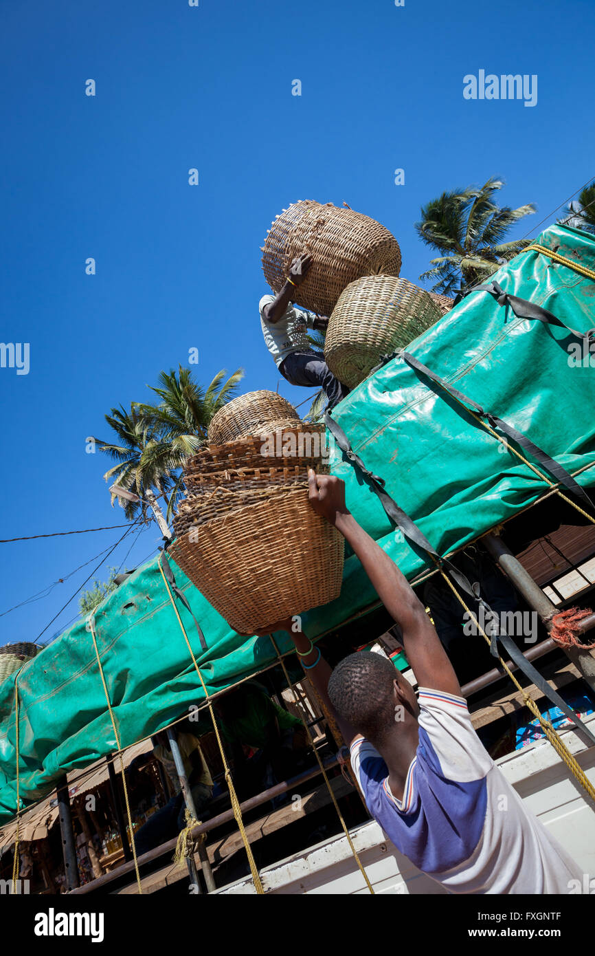 Mozambique, men are carrying the truck at the market on the street ...