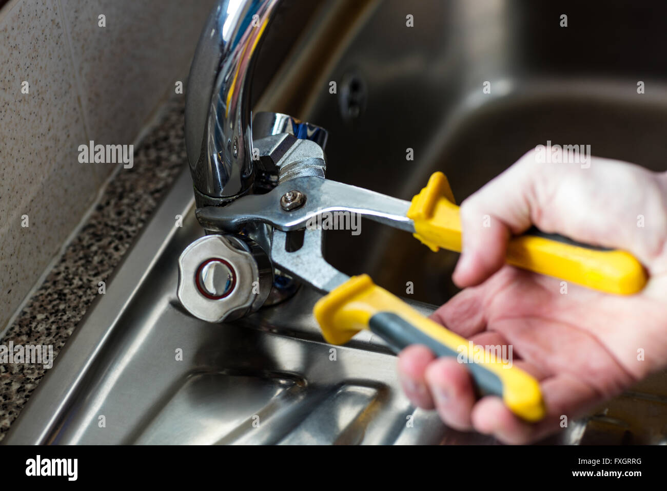 Man fixing kitchen sink hi-res stock photography and images - Alamy