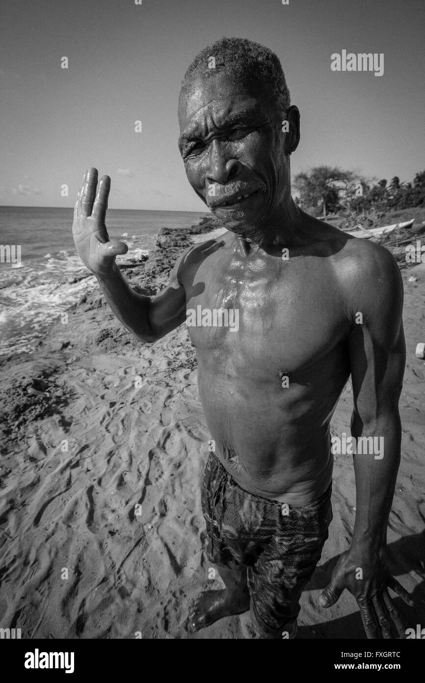 Mozambique, man saying hello on the beach, white sand, black and white ...