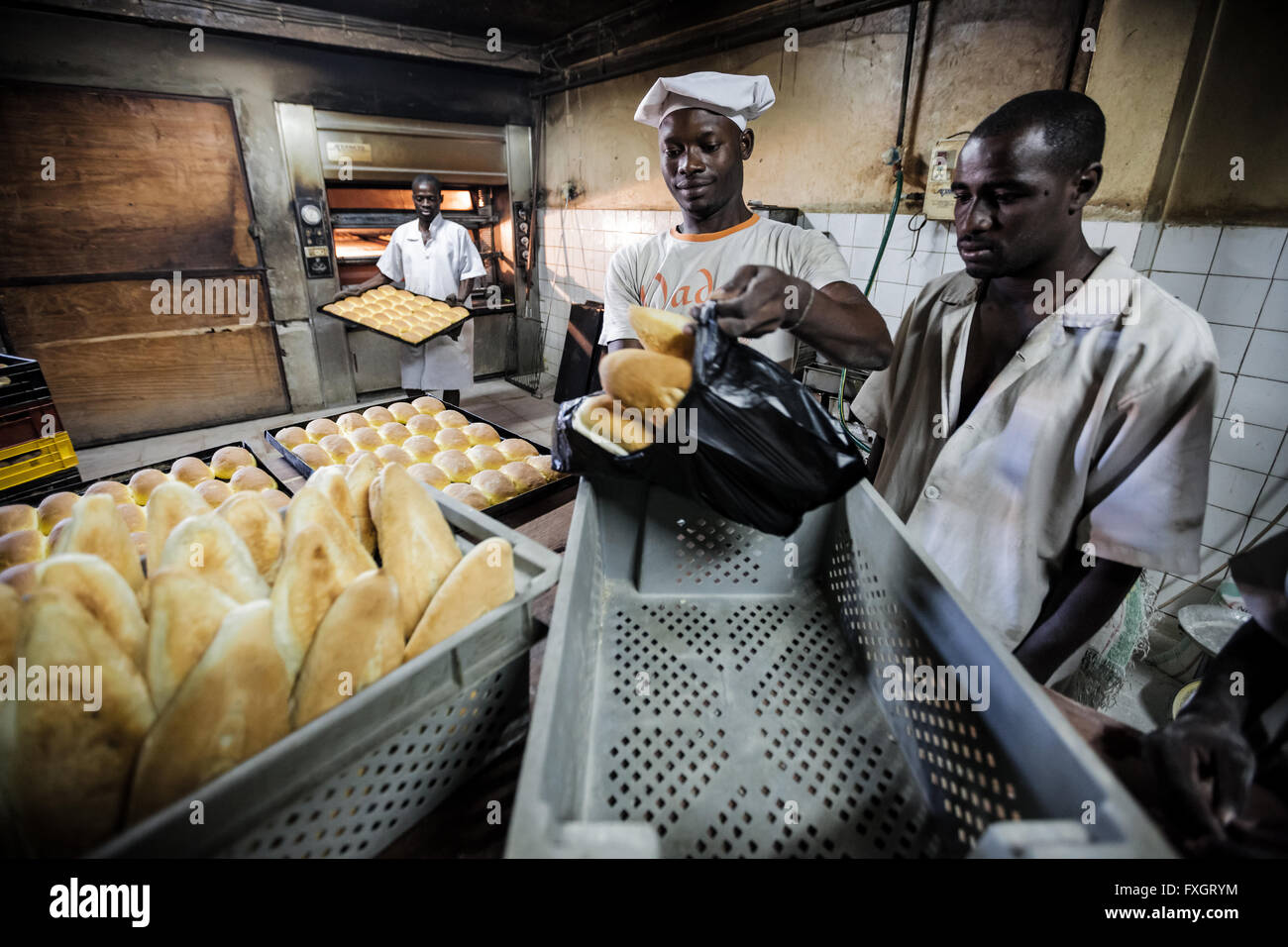 Mozambique, men are baking bread in bakery traditional cousin Stock ...