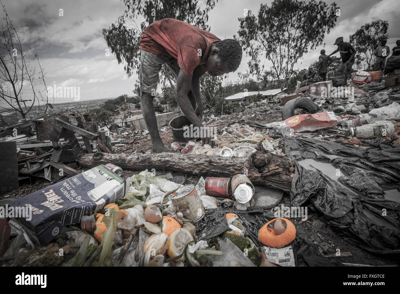 Mozambique, men in the middle of rubbish Stock Photo - Alamy