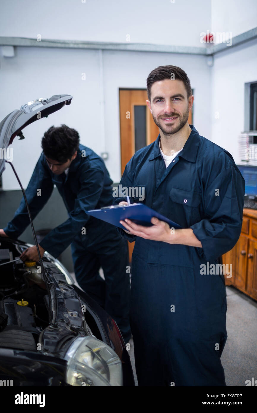 Mechanic preparing a check list Stock Photo - Alamy