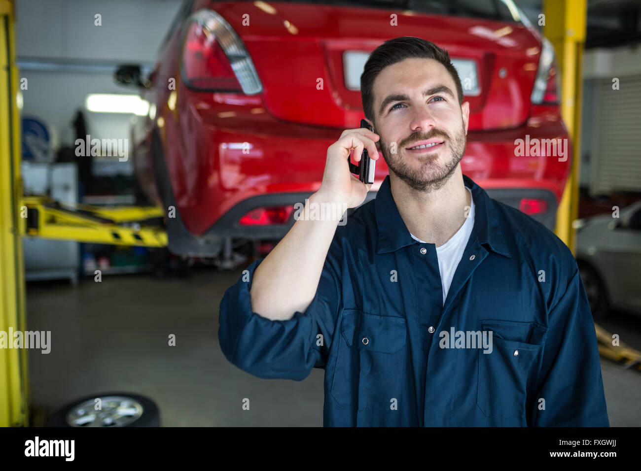 Young garage mechanic talking hi-res stock photography and images - Alamy