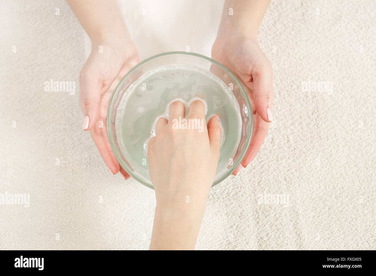 Manicure process hand in bath for manicure Stock Photo - Alamy