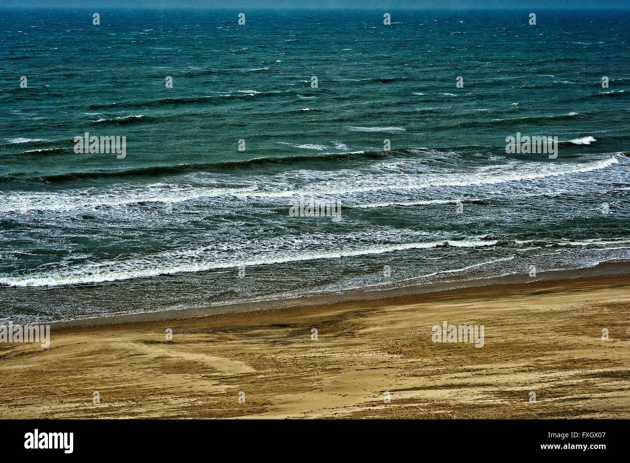 Windswept winter beach with blown sand and surf Stock Photo - Alamy