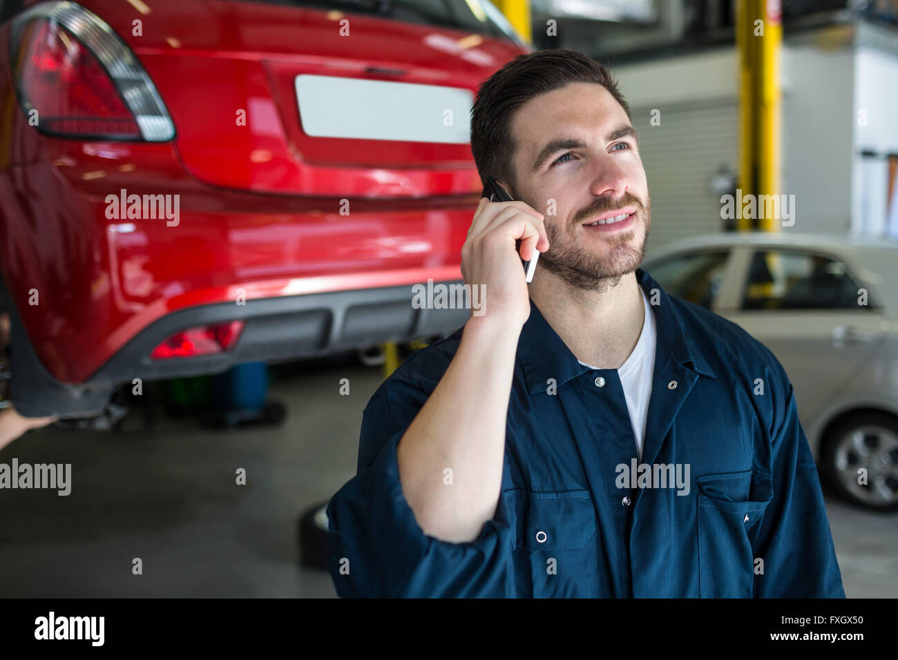 Mechanic talking on a mobile phone Stock Photo - Alamy