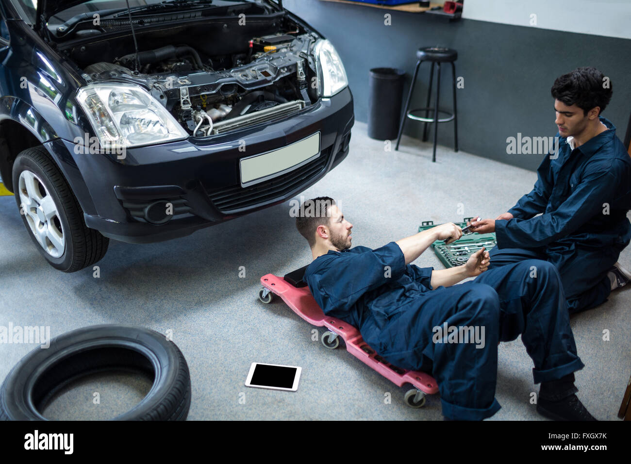 Mechanics repairing a car Stock Photo - Alamy