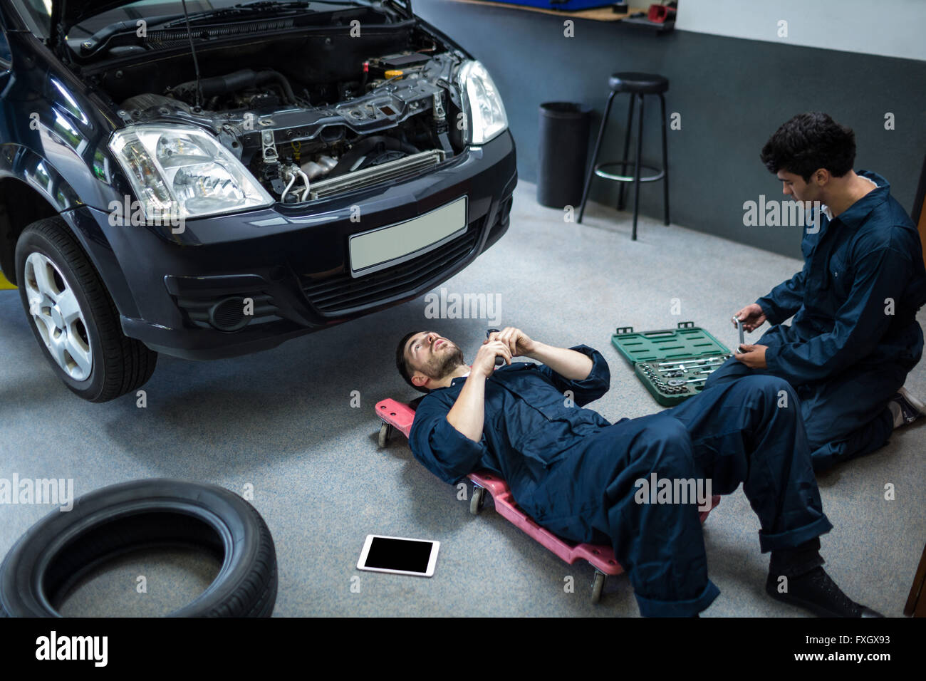 Mechanics repairing a car Stock Photo - Alamy