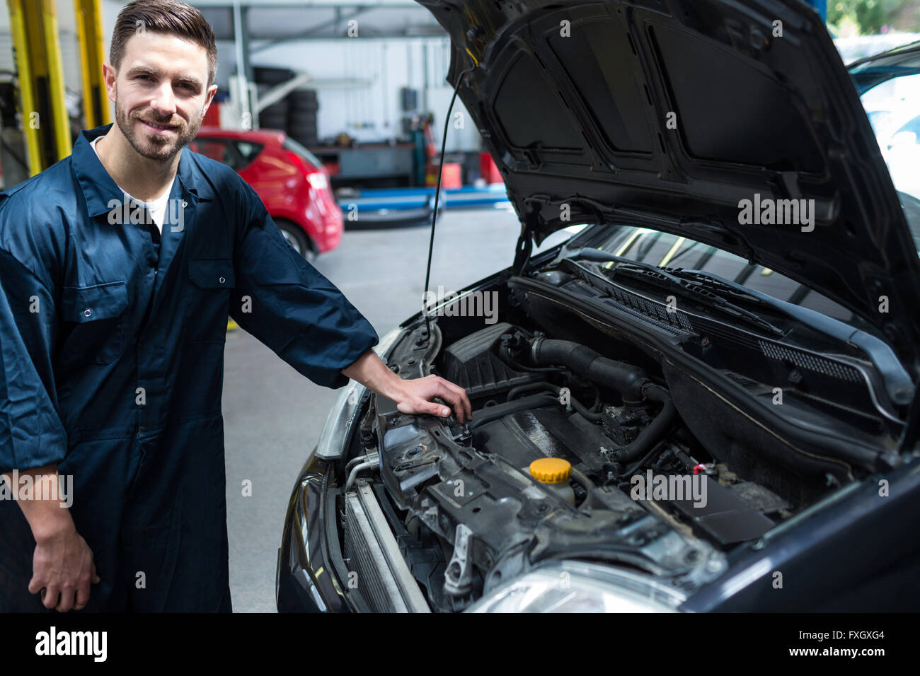 Smiling mechanic looking at camera Stock Photo - Alamy