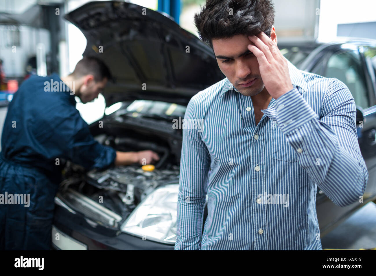 Customer feeling worried about his car Stock Photo - Alamy