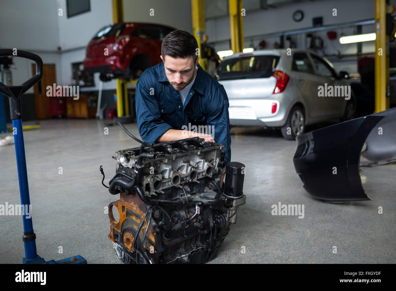 Mechanic working on an engine Stock Photo - Alamy