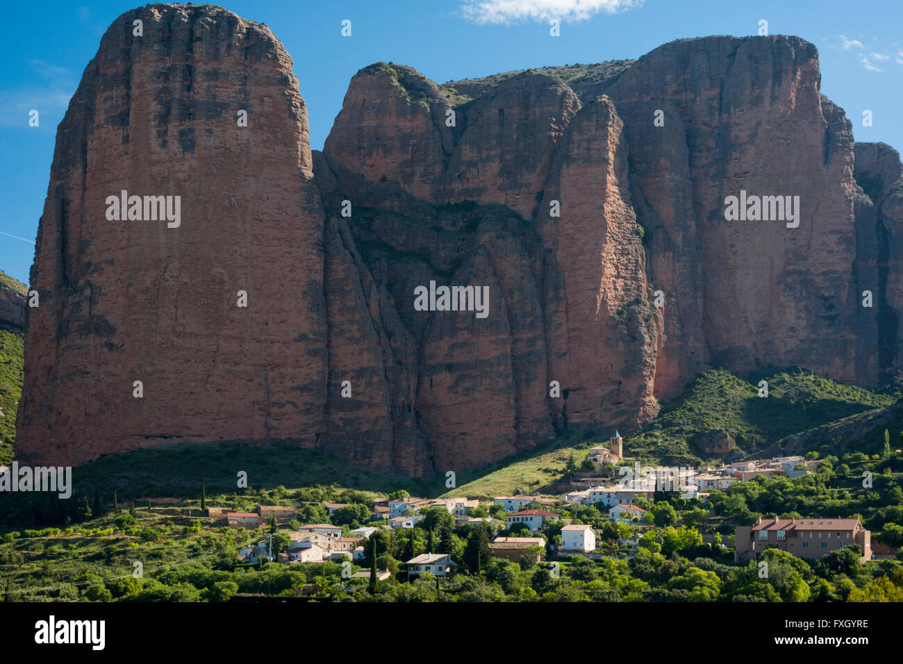 Village of Riglos beneath the conglomerate rock formations of the ...