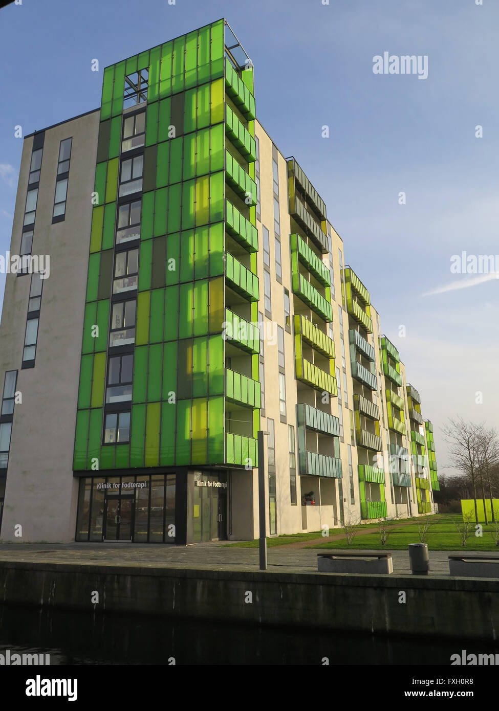 Green colored block of flats on canal-side in Copenhagen, Denmark Stock ...