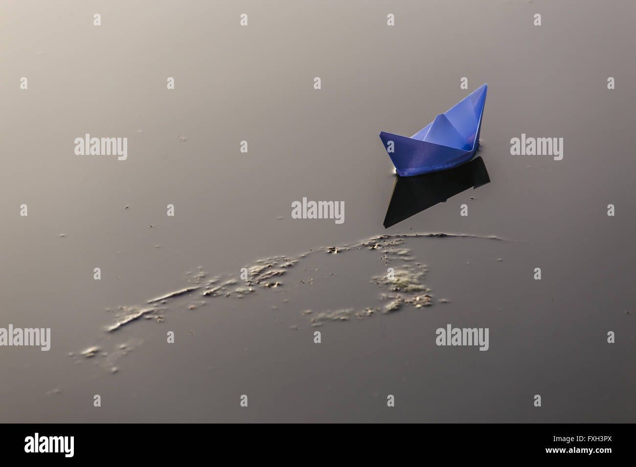 paper boat sailing on water surface at sunset Stock Photo - Alamy