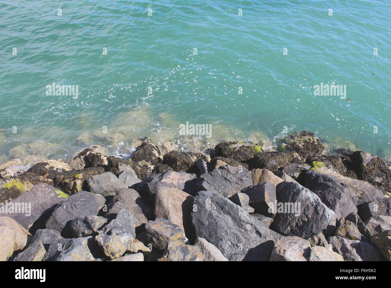 Water and stones background in Howth, Ireland Stock Photo - Alamy