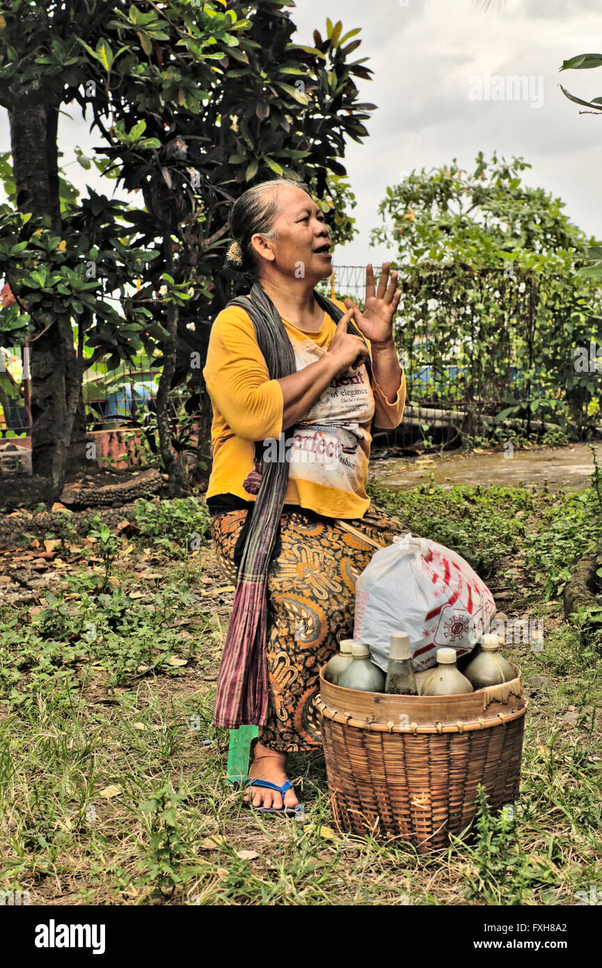 A Javaese woman seller of jamu, traditional Indonesian medicine, which ...