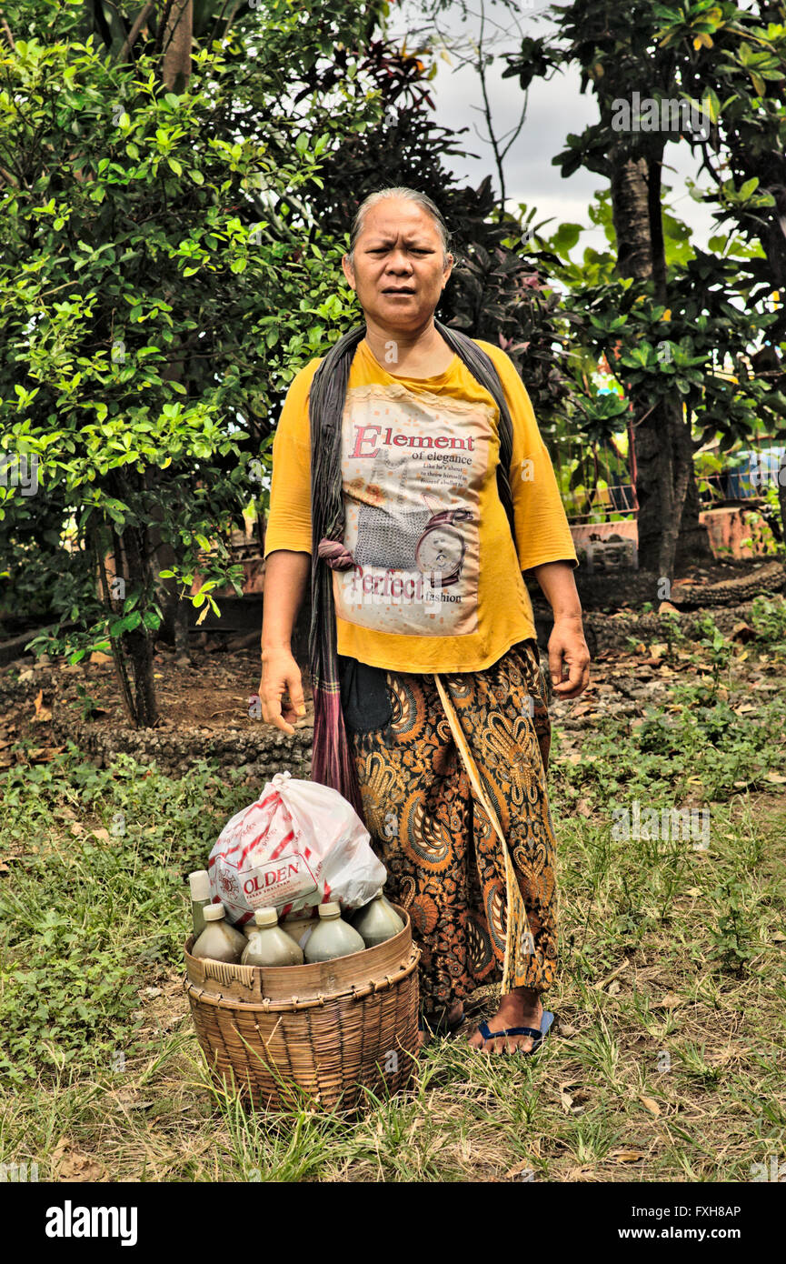A Javaese woman seller of jamu, traditional Indonesian medicine, which ...