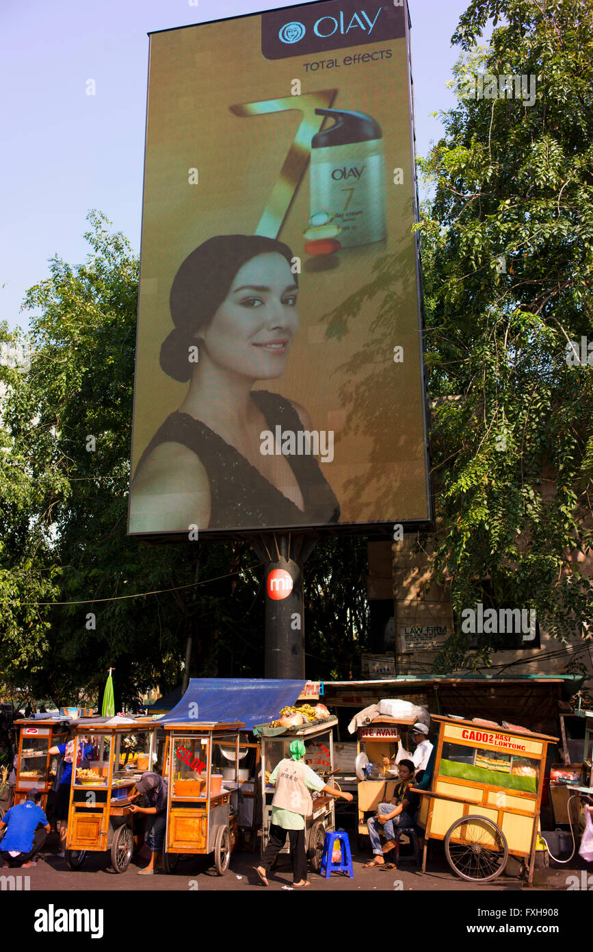 Cheap food vendors in central Jakarta below a billboard displaying ...