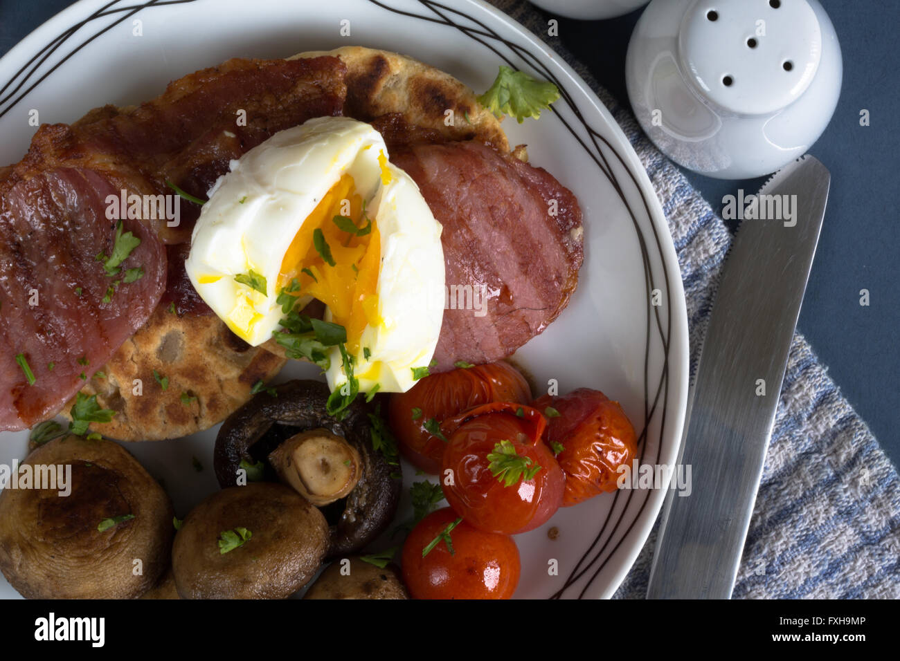 An English style breakfast of Welsh Cake, Bacon, Mushrooms, Tomatoes ...