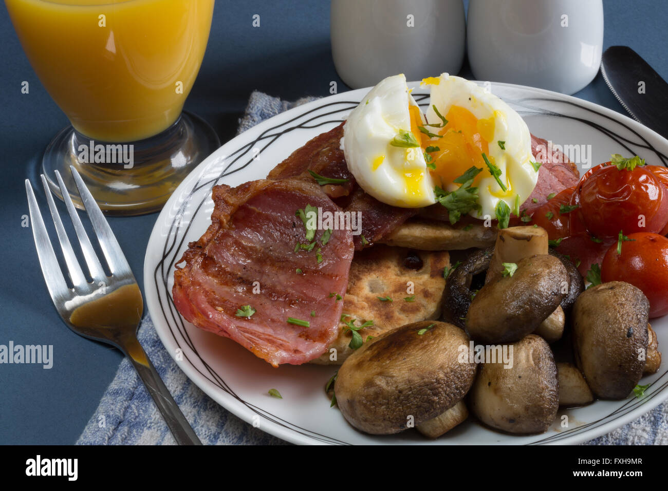 An English style breakfast of Welsh Cake, Bacon, Mushrooms, Tomatoes ...