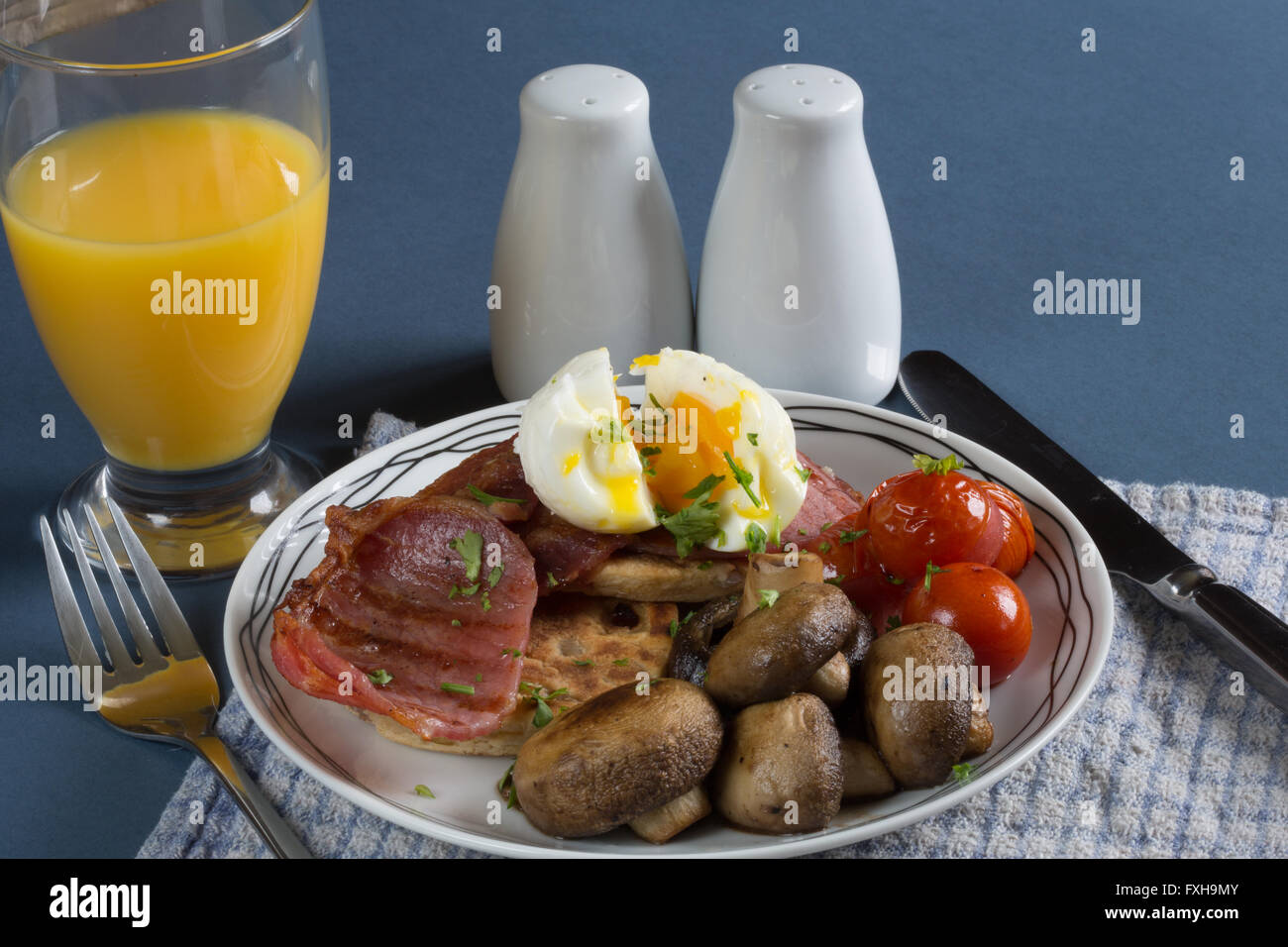An English style breakfast of Welsh Cake, Bacon, Mushrooms, Tomatoes ...