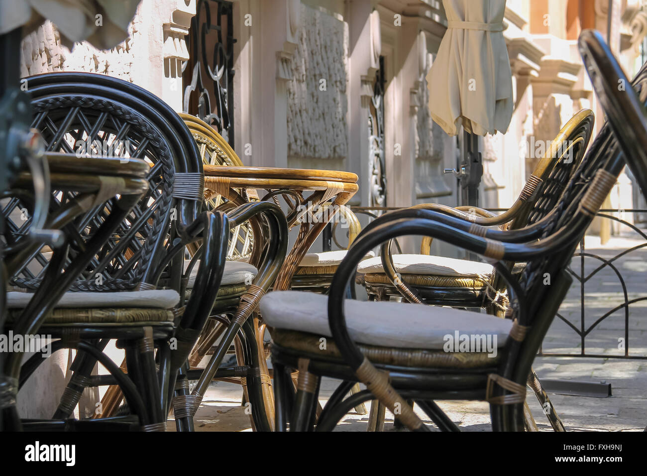 Outdoor street cafe with wooden furniture in touristic city centre ...