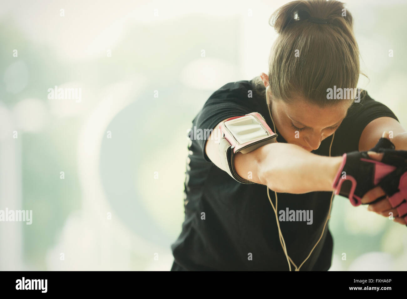 Woman with mp3 player armband stretching arms Stock Photo - Alamy