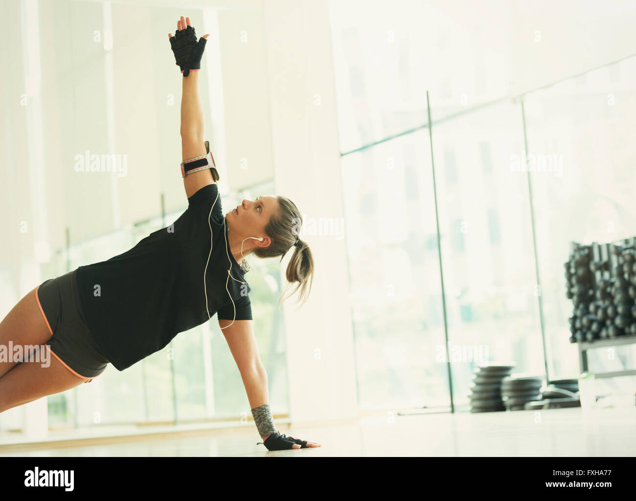 Woman balancing in side plank in gym studio Stock Photo - Alamy